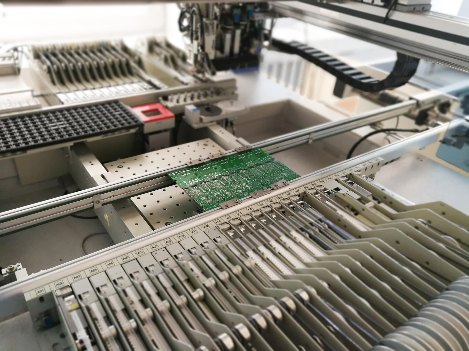 PCB assembly first stages. PCB on the rails of production line inside ...